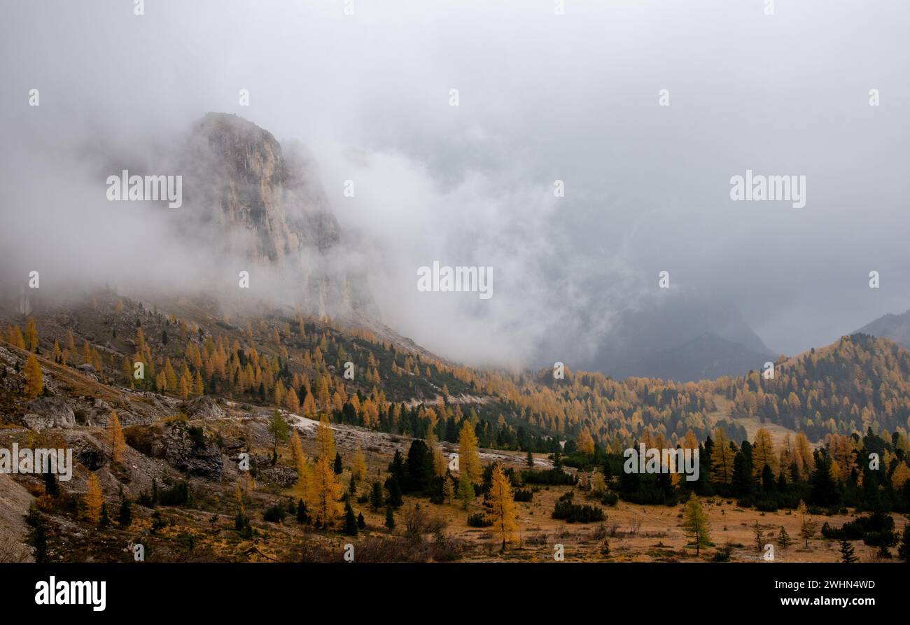 Dolomite mountain peaks covered in fog during sunrise Stock Photo - Alamy