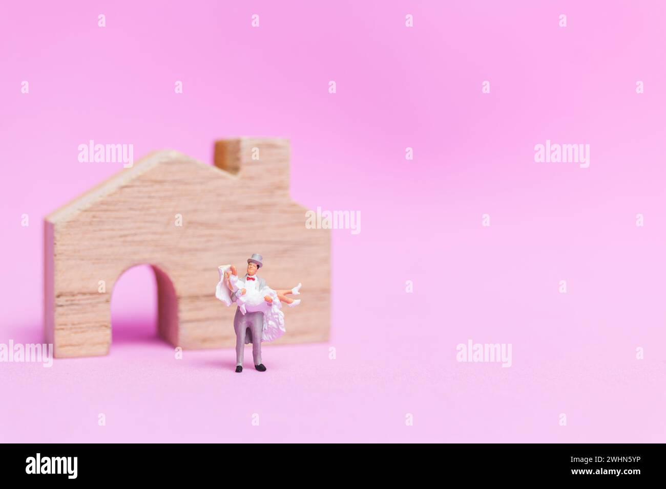 Miniature people wedding , bride and groom couple on pink background ...