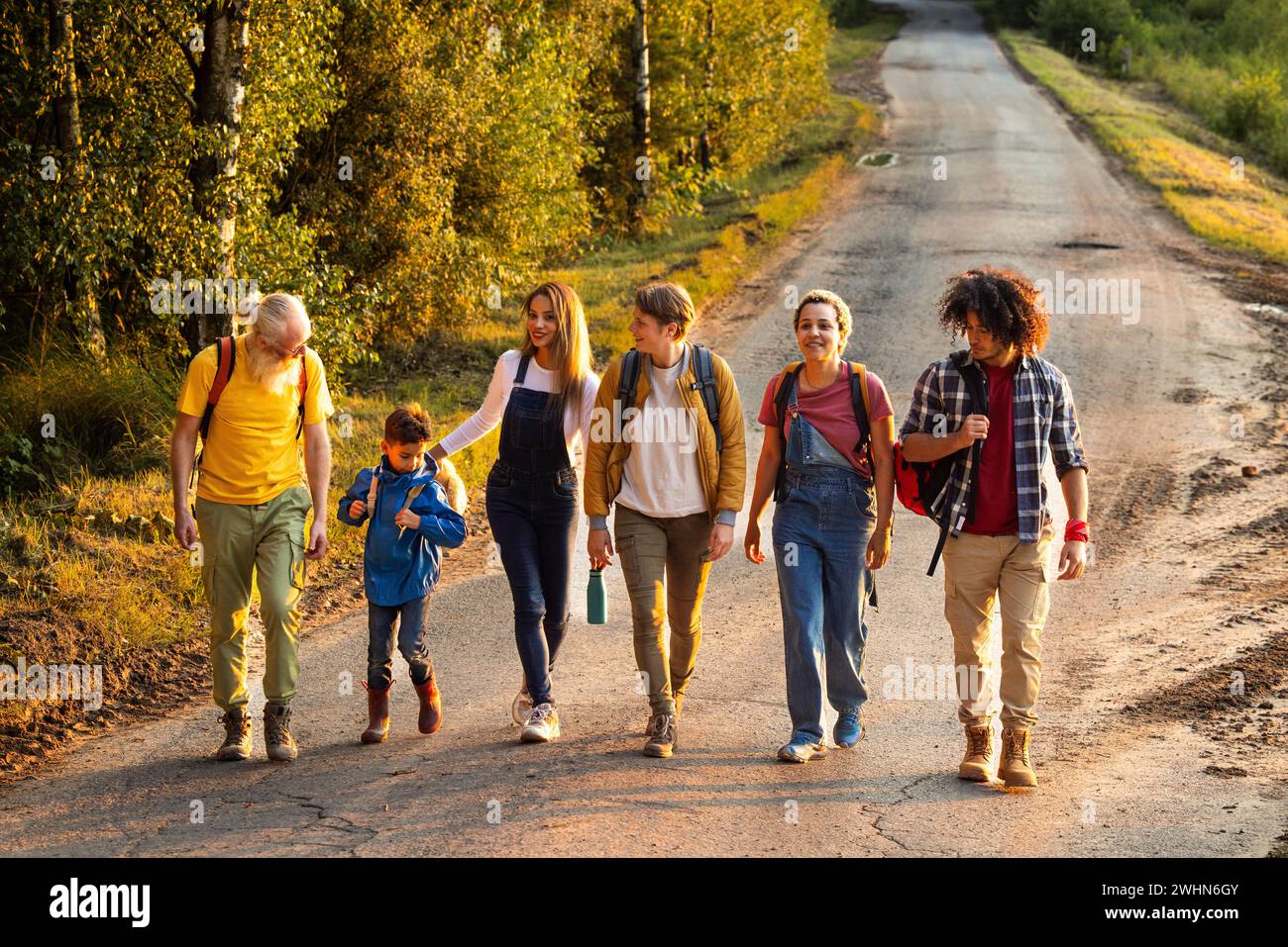 Friends on walk in beautiful rural nature in a landscape behind village ...