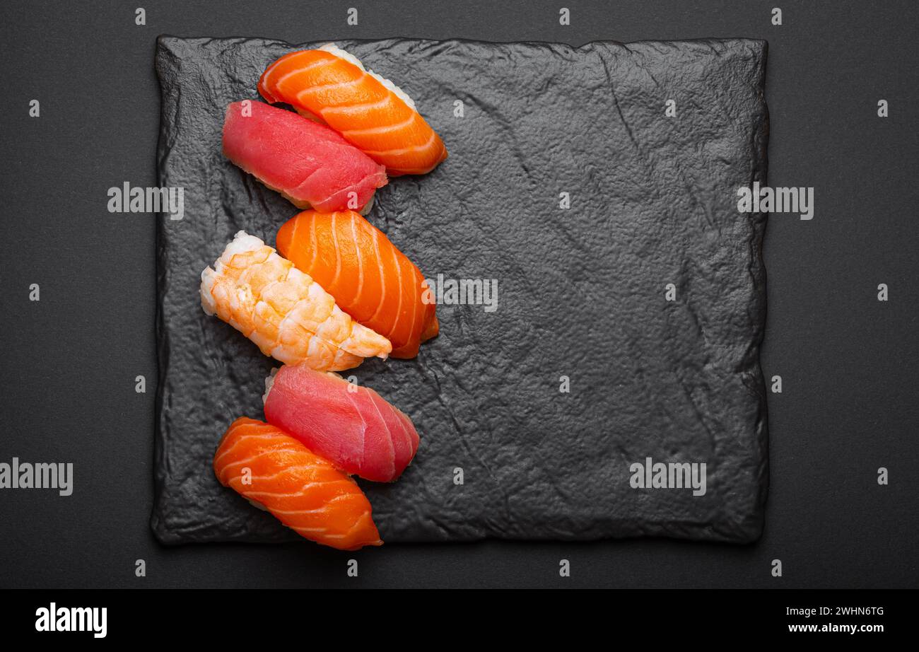 Traditional Japanese sushi top view on dark black rustic slate. Sushi ...