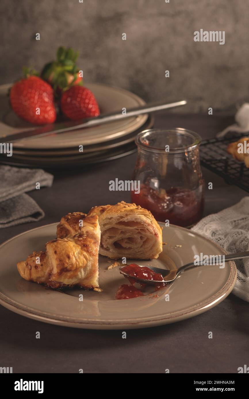 Baked croissants with strawberry jam Stock Photo - Alamy