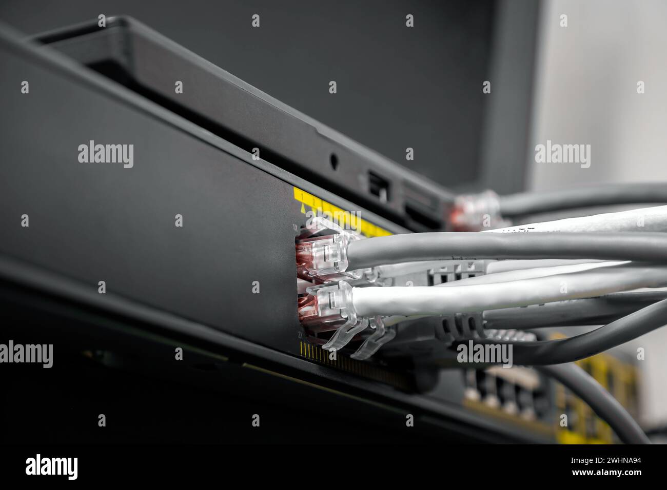 Network Gigabit Smart PoE Switch with connected network cables getting ...