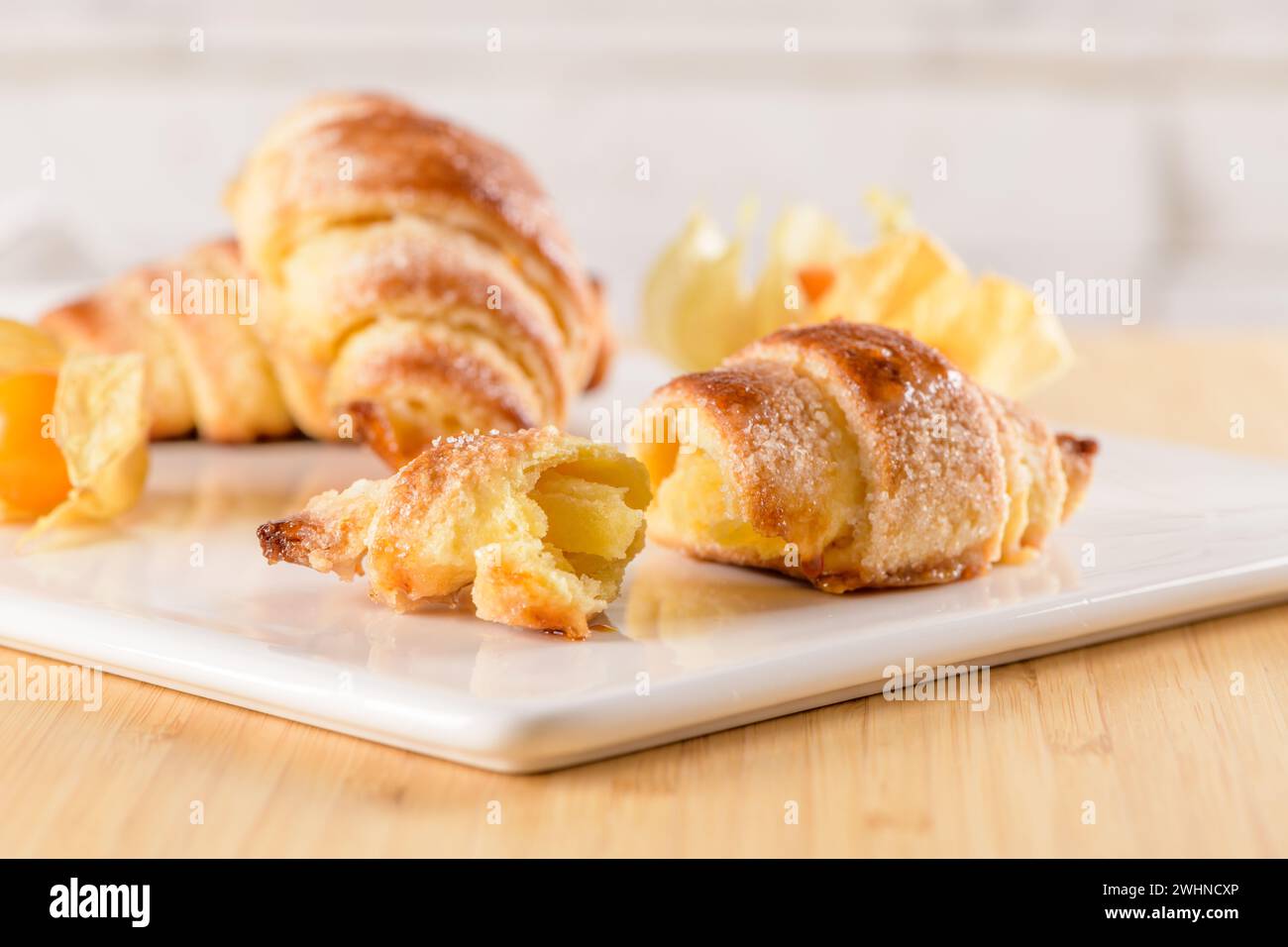 Small croissant with physalis fruits Stock Photo - Alamy