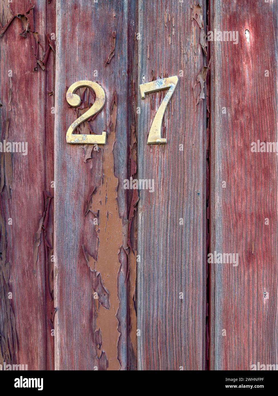 Number 27 on red painted old wooden wall Stock Photo - Alamy