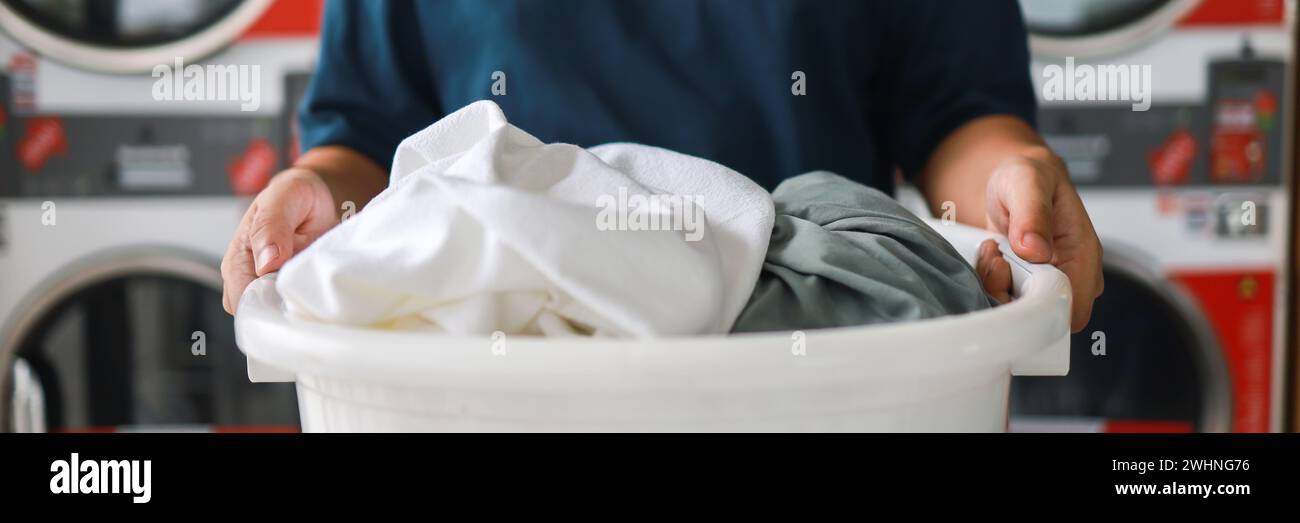 Man doing launder holding basket with dirty laundry of the washing ...