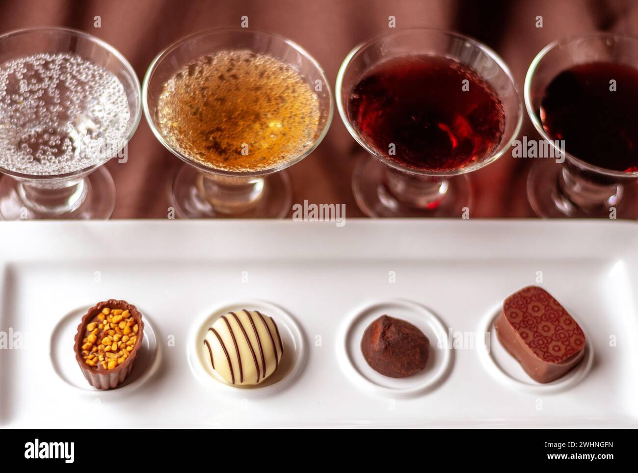 Small tastes of different wines from sparkling to dessert wine, are set ...