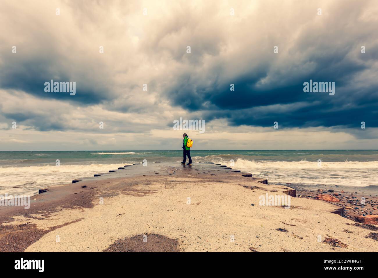 Traveler on the beach near sea looking far away at horizon, Wild surf ...