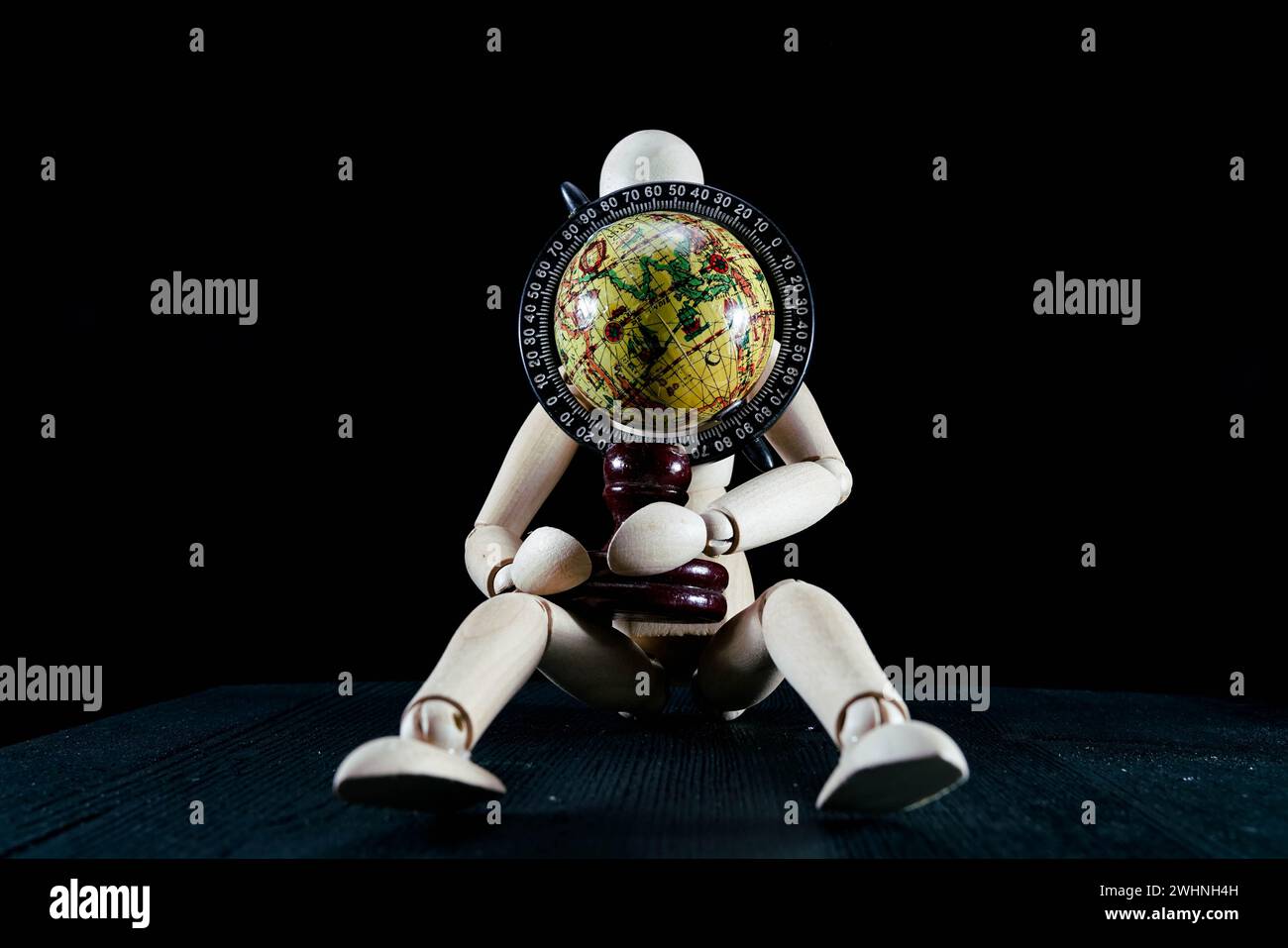 Wooden dummy and earth globe, ecology concept, puppet made of wood, art ...