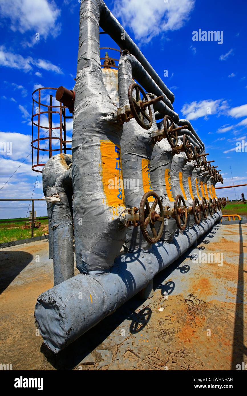 Oil pipes and valves Stock Photo - Alamy