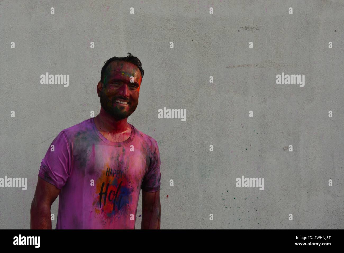 Portrait of a young Indian boy playing holi. Happy boy enjoying in holi ...