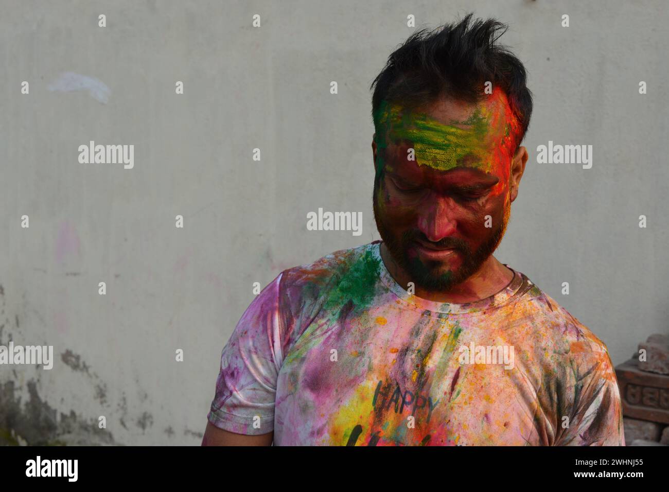 Portrait of a young Indian boy playing holi. Happy boy enjoying in holi ...