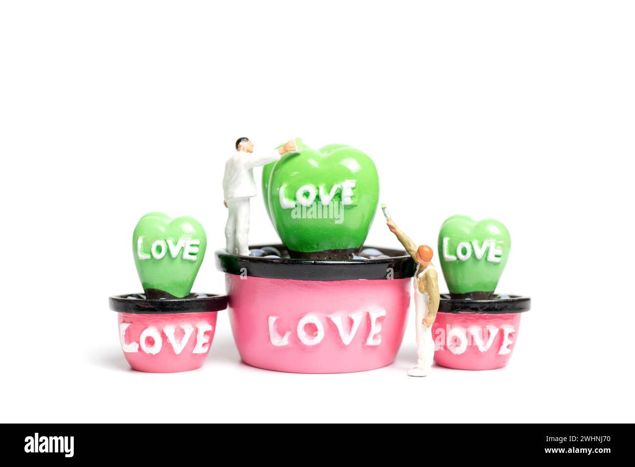 Miniature people : Painters coloring plant in a pod with love word ...