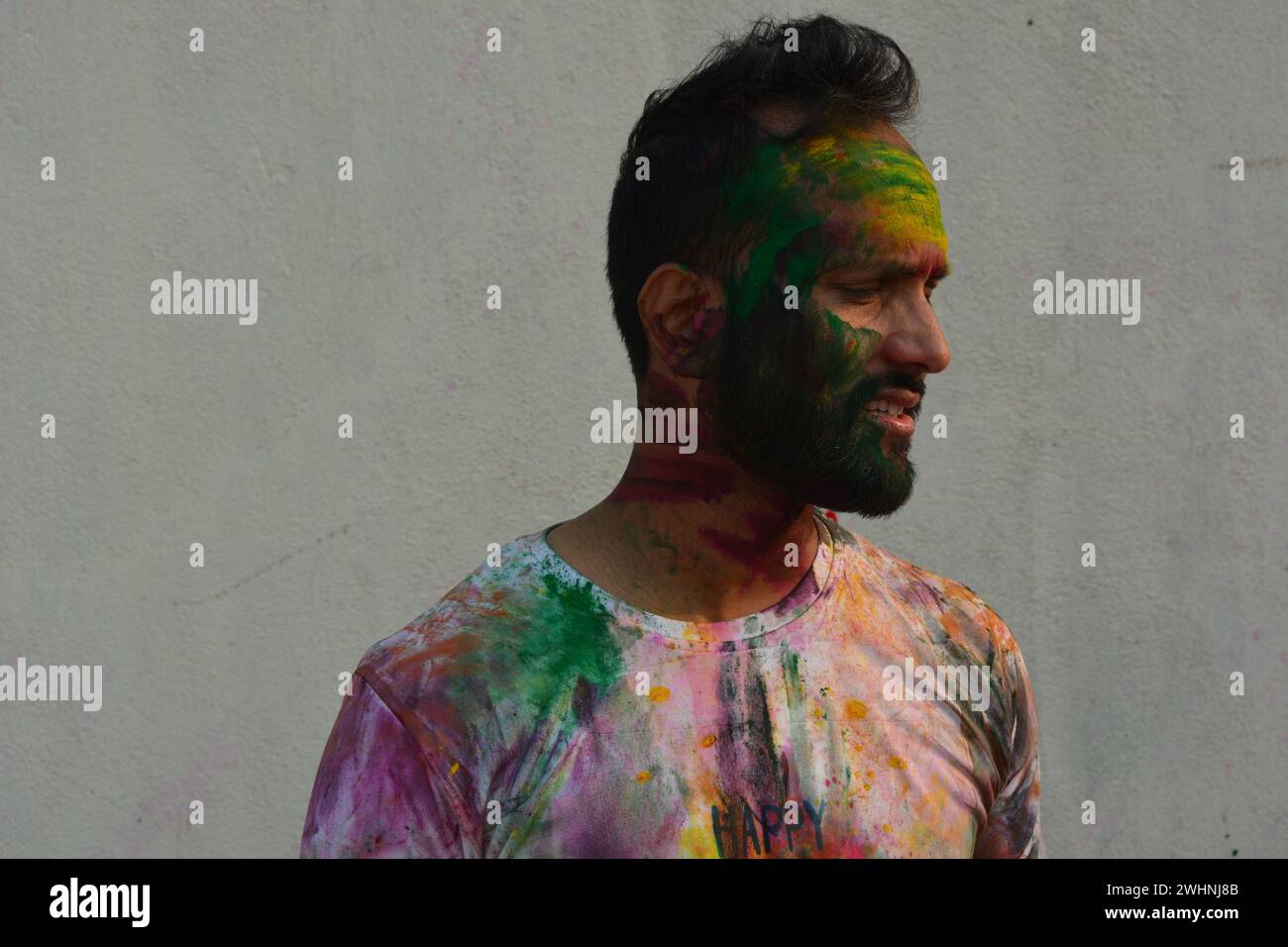 Portrait of a young Indian boy playing holi. Happy boy enjoying in holi ...