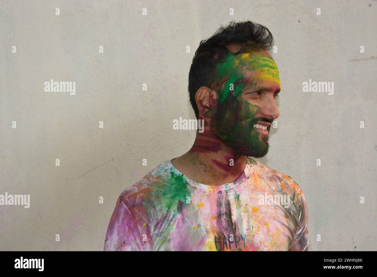 Portrait of a young Indian boy playing holi. Happy boy enjoying in holi ...