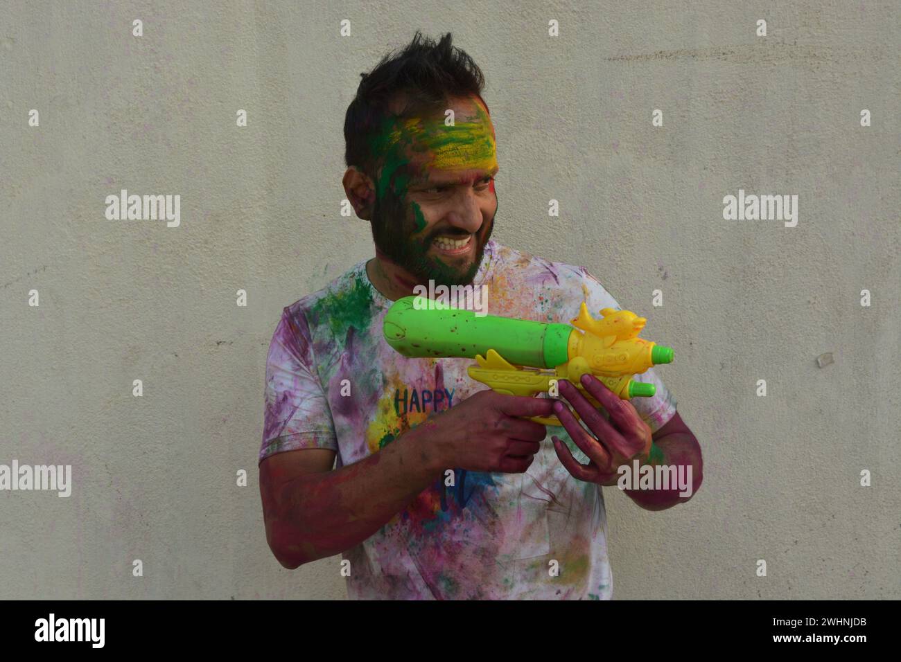 Portrait of a young Indian boy playing holi. Happy boy enjoying in holi ...