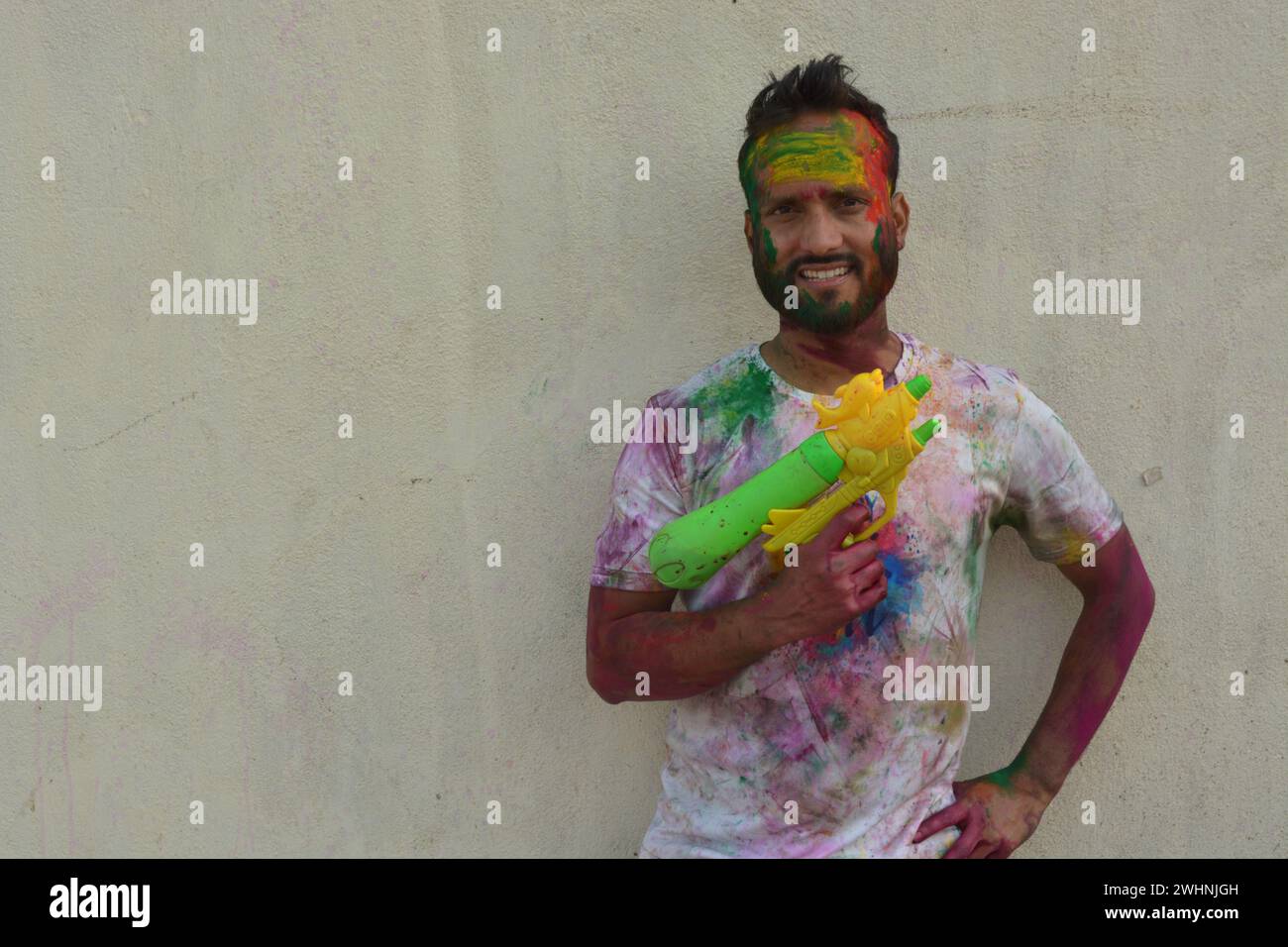 Portrait of a young Indian boy playing holi. Happy boy enjoying in holi ...