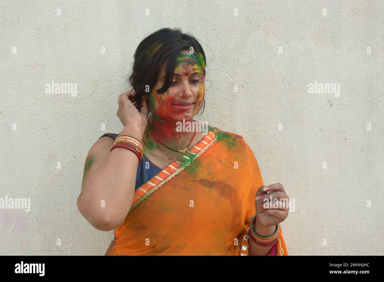 Portrait of a young Indian girl playing holi. Happy female enjoying in ...