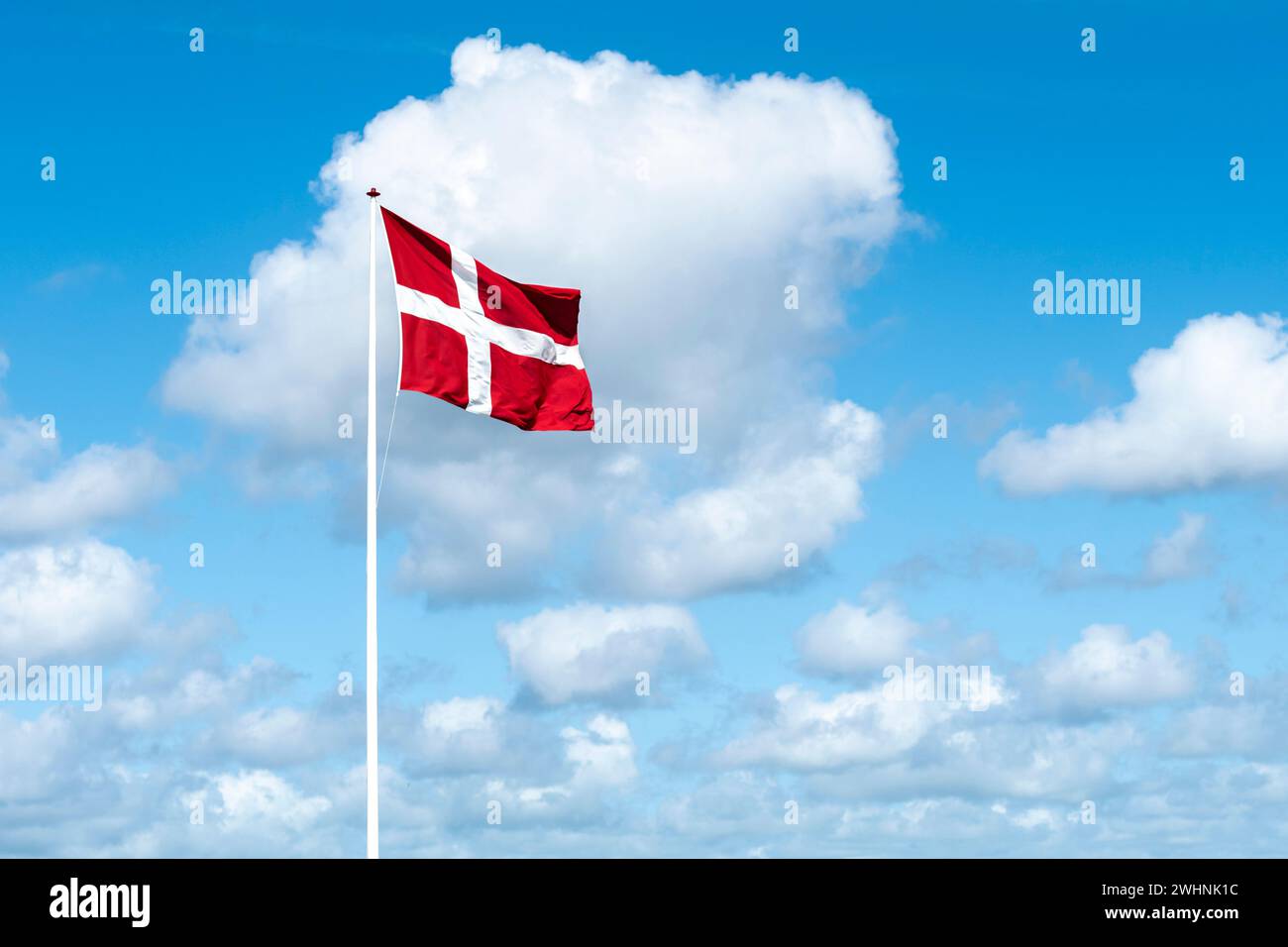Flag of Denmark against blue sky Stock Photo - Alamy