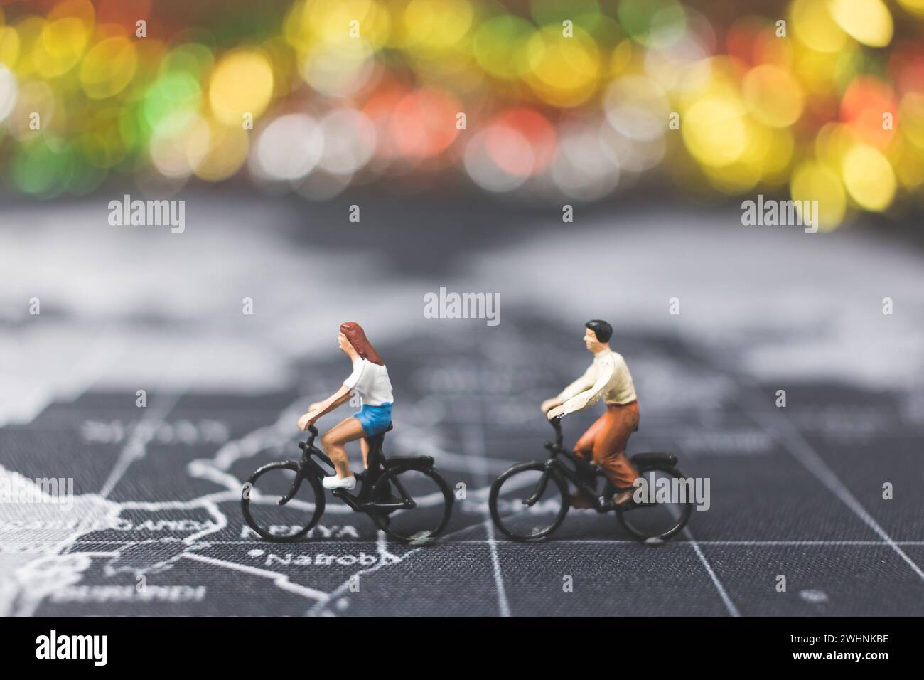 Miniature people travelers riding bicycle on world map Stock Photo - Alamy