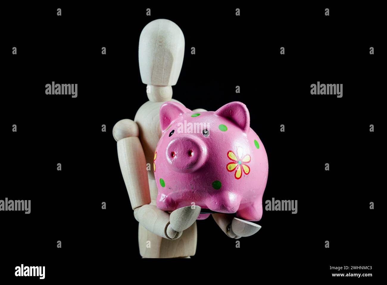 Wooden dummy and piggy bank, business concept, bank concept, puppet ...