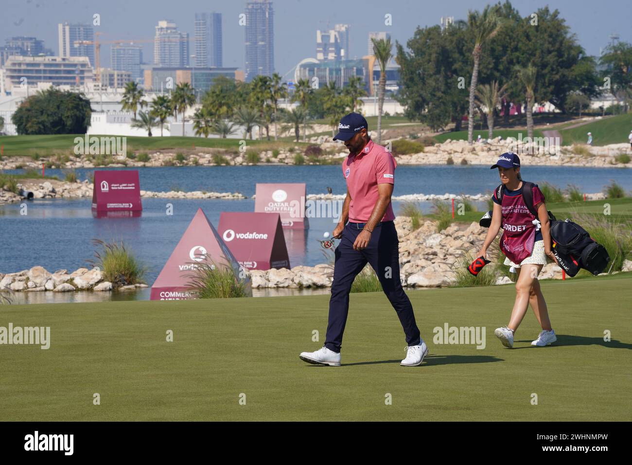 Golfers in action at the Commercial Bank Qatar Masters golf tournament ...