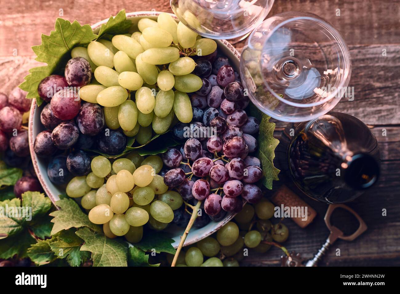 Wine Glasses and Grapes on wood table Stock Photo - Alamy
