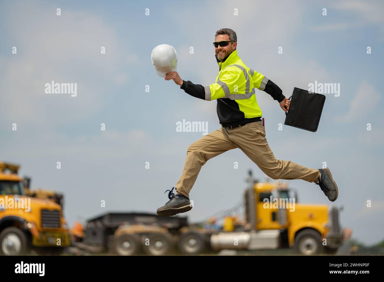 Hispanic builder excited jump and run on site construction. Excited ...