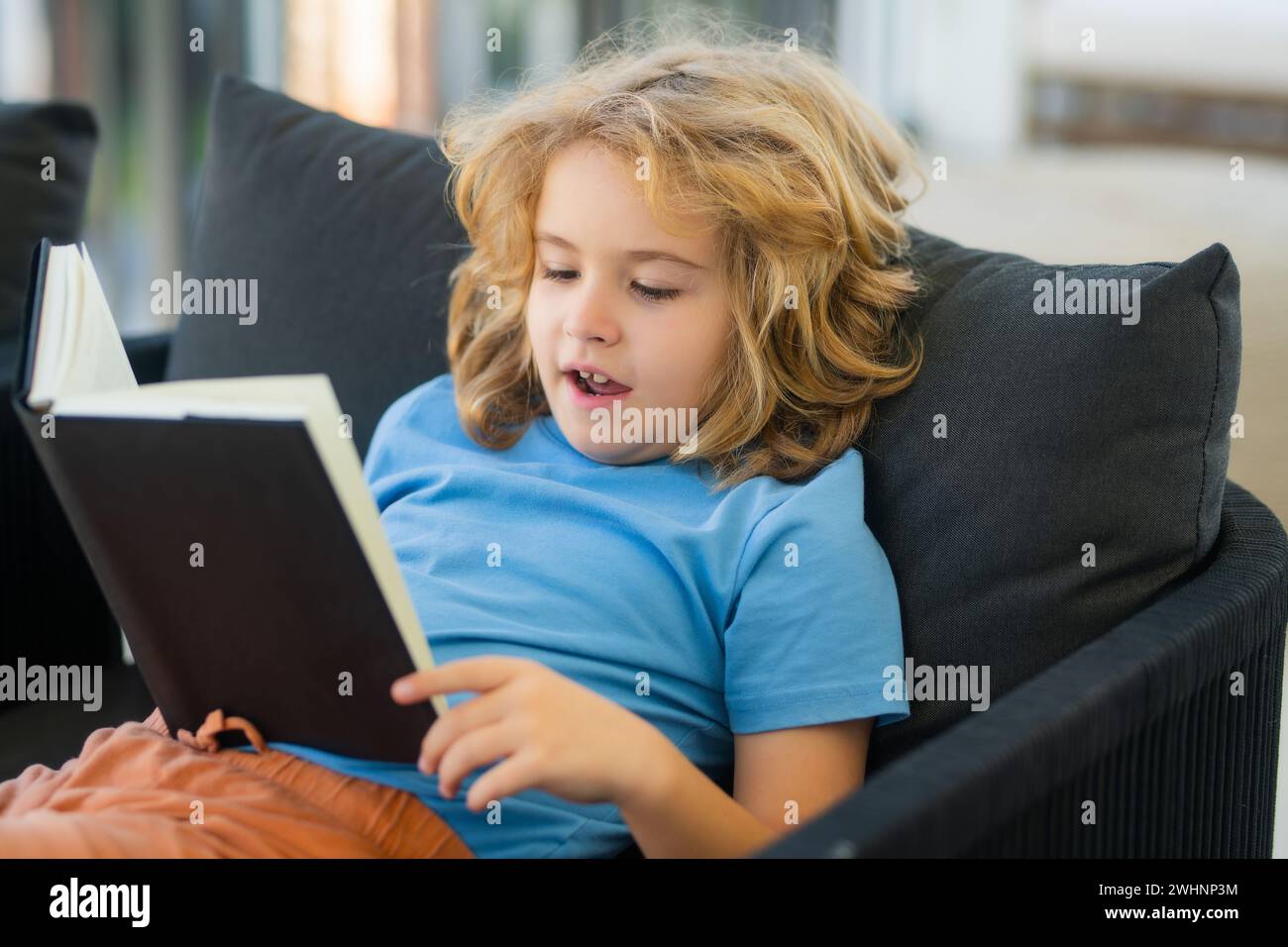 Imagination child. Child reading book at home. Little boy sitting on ...