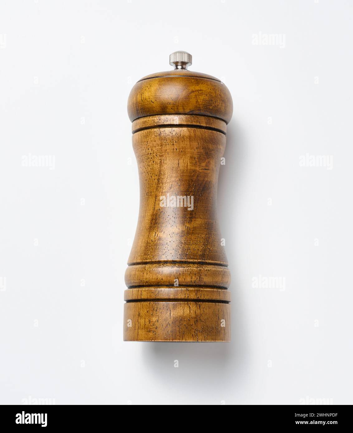Wooden pepper mill on a white background, made of wood and has a metal ...