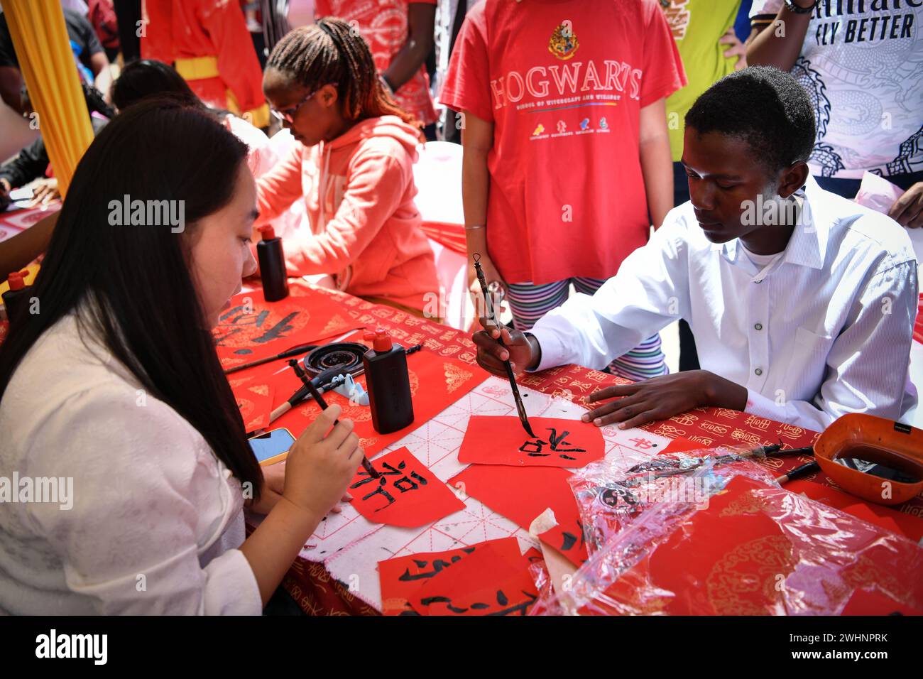 Nairobi, Kenya. 10th Feb, 2024. People try Chinese calligraphy during ...