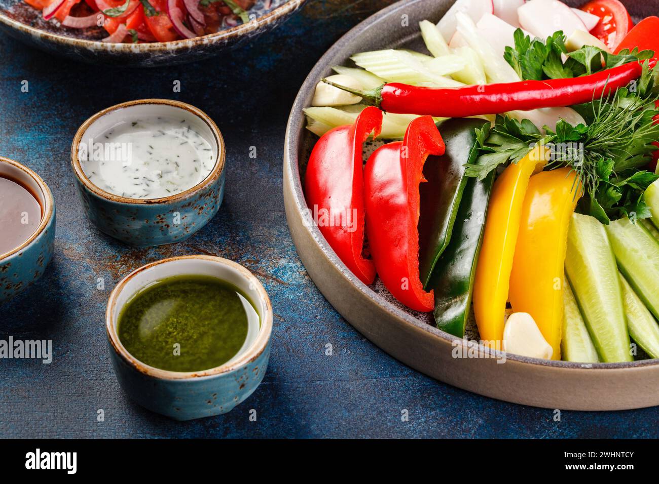 Dish with vegetables, peppers, tomatoes and greens and various types of ...