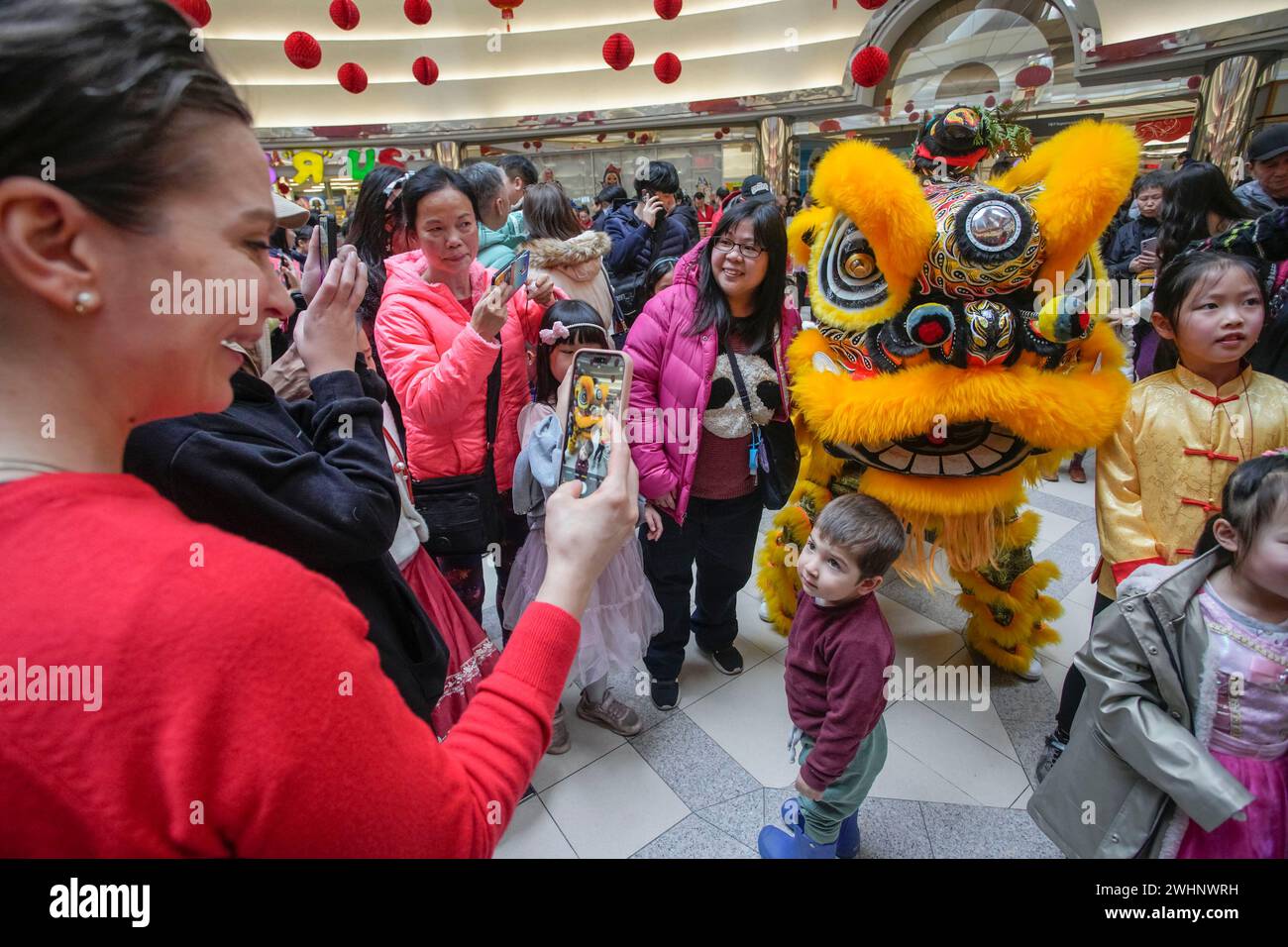 Richmond, Canada. 10th Feb, 2024. People pose for photos with a lion ...