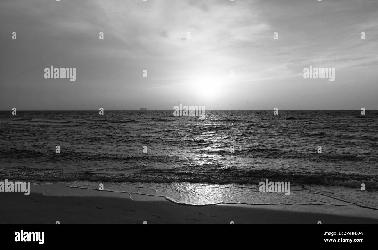 beautiful sundown sky with waves on sea water Stock Photo - Alamy