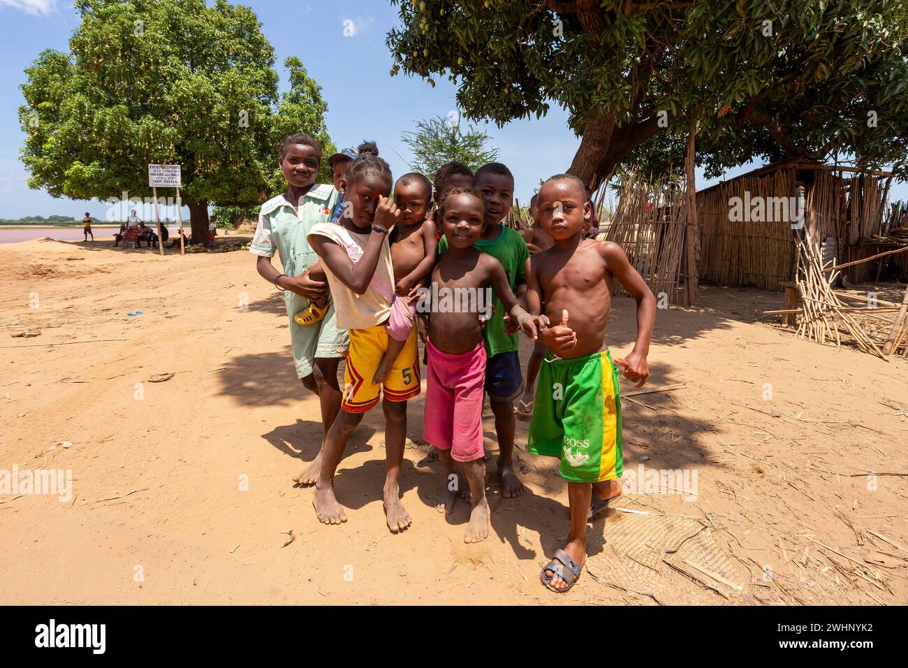 Curious group of children looking at a tourist near the river Mania ...