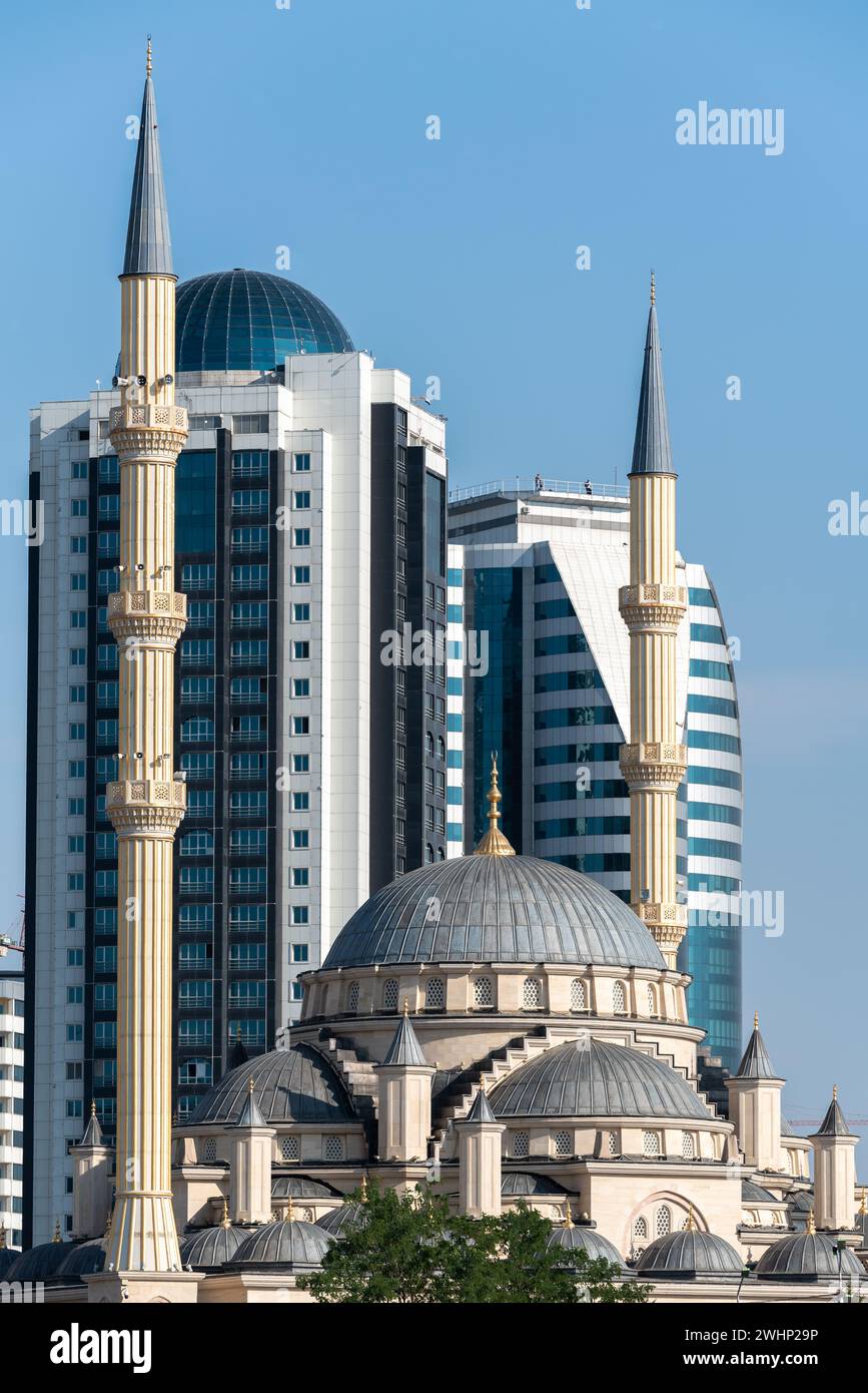 Minaret of traditional Islamic mosque and tall modern skyscrapers in ...