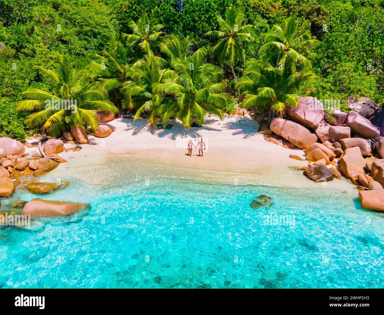 Anse Lazio Praslin Seychelles, young couple men and woman on a tropical ...