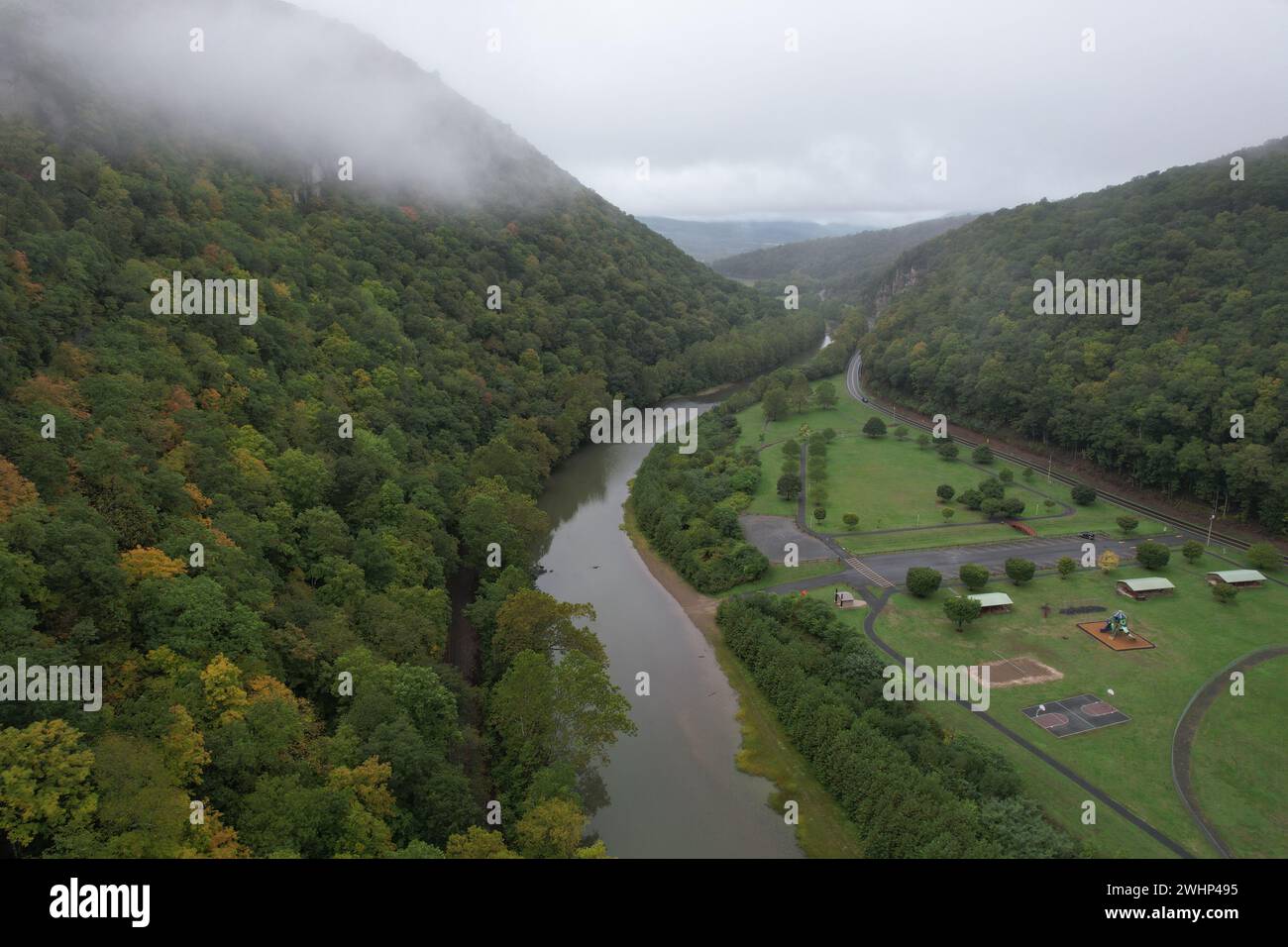 Aerial view of a tree-lined valley in the distance Stock Photo - Alamy