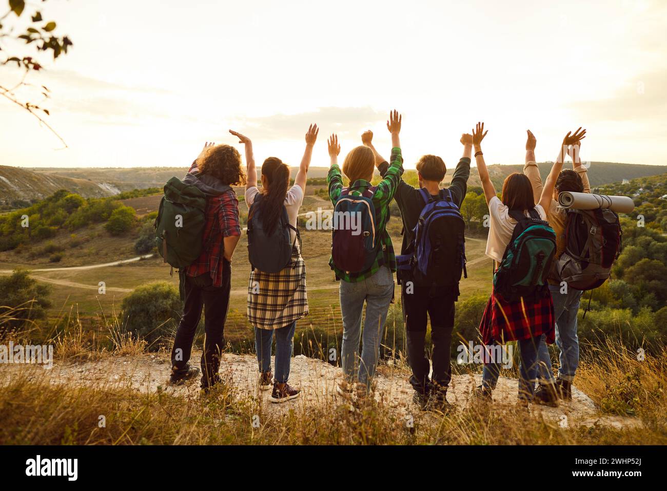 Back view of men and women hikers looking into the distance during ...