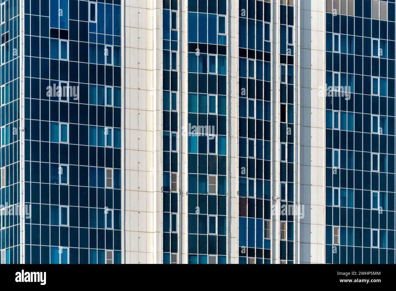Many windows and walls facade of a modern skyscraper without people ...