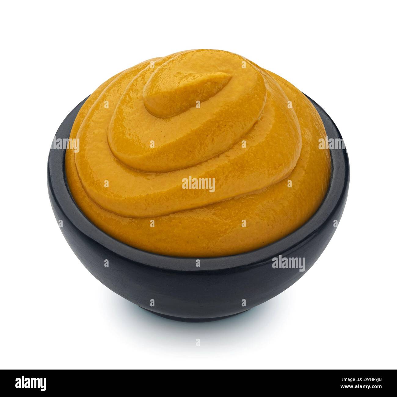 Mustard in black bowl isolated on white background, full depth of field ...