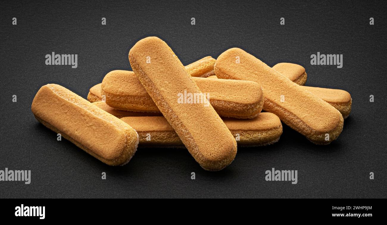 Italian biscuits on black background, ladyfinger cookies, full depth of ...