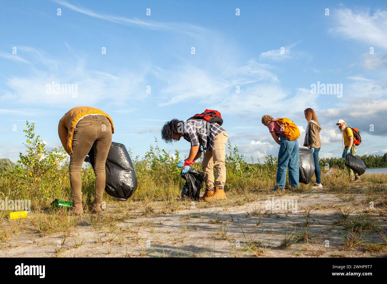 Diverse Friends Cleaning the Lake Shore Stock Photo - Alamy