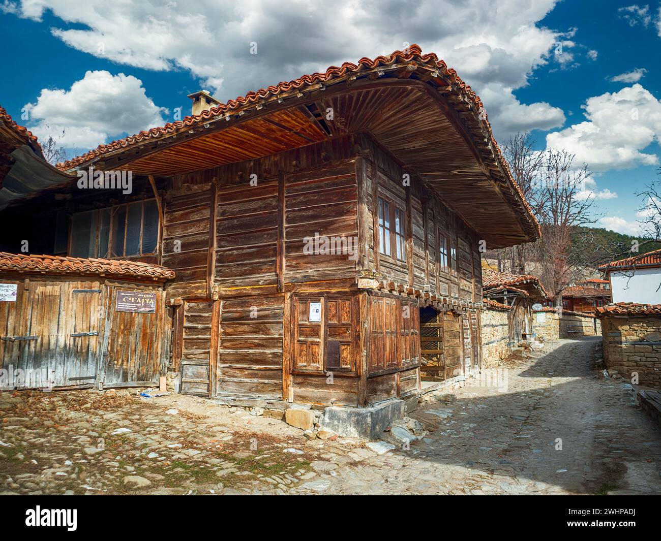 Zheravna, Bulgaria - narrow cobbled road and rustic traditional houses ...
