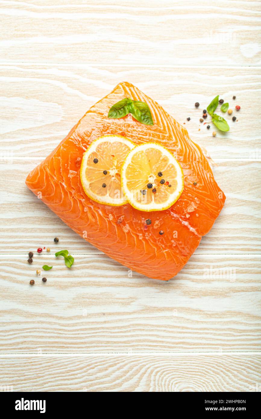 Fresh raw salmon marbled fillet on white rustic wooden table background ...