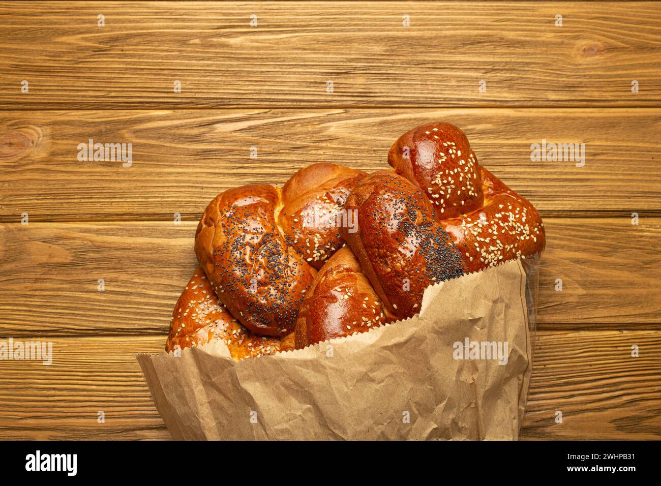 Freshly baked Challah bread covered with poppy and sesame seeds in a ...