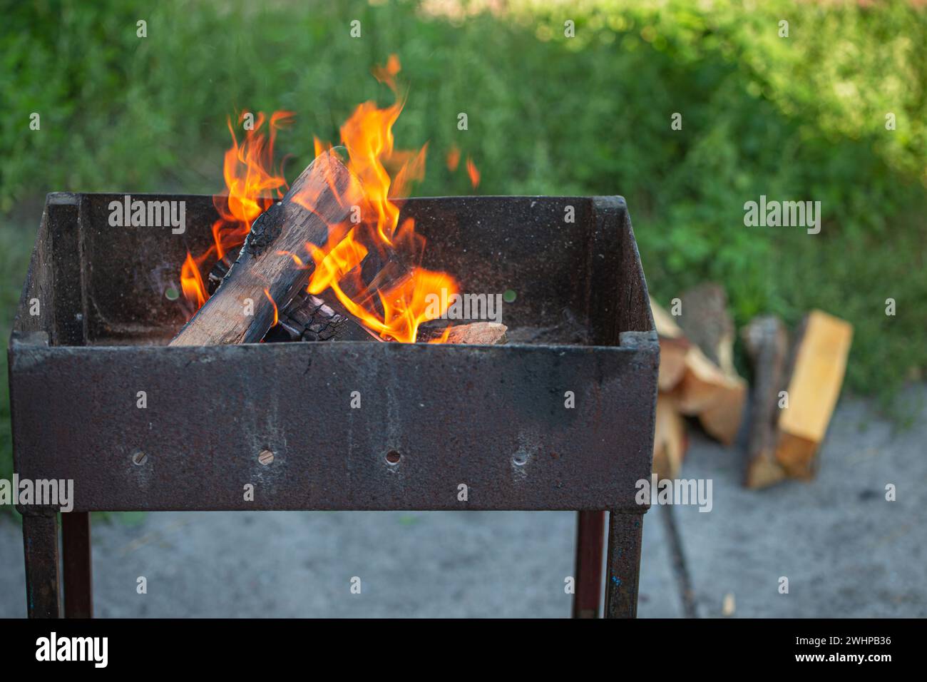 Open Air Rustic Metal Barbecue Grill with Firewood. Fire flame for BBQ ...