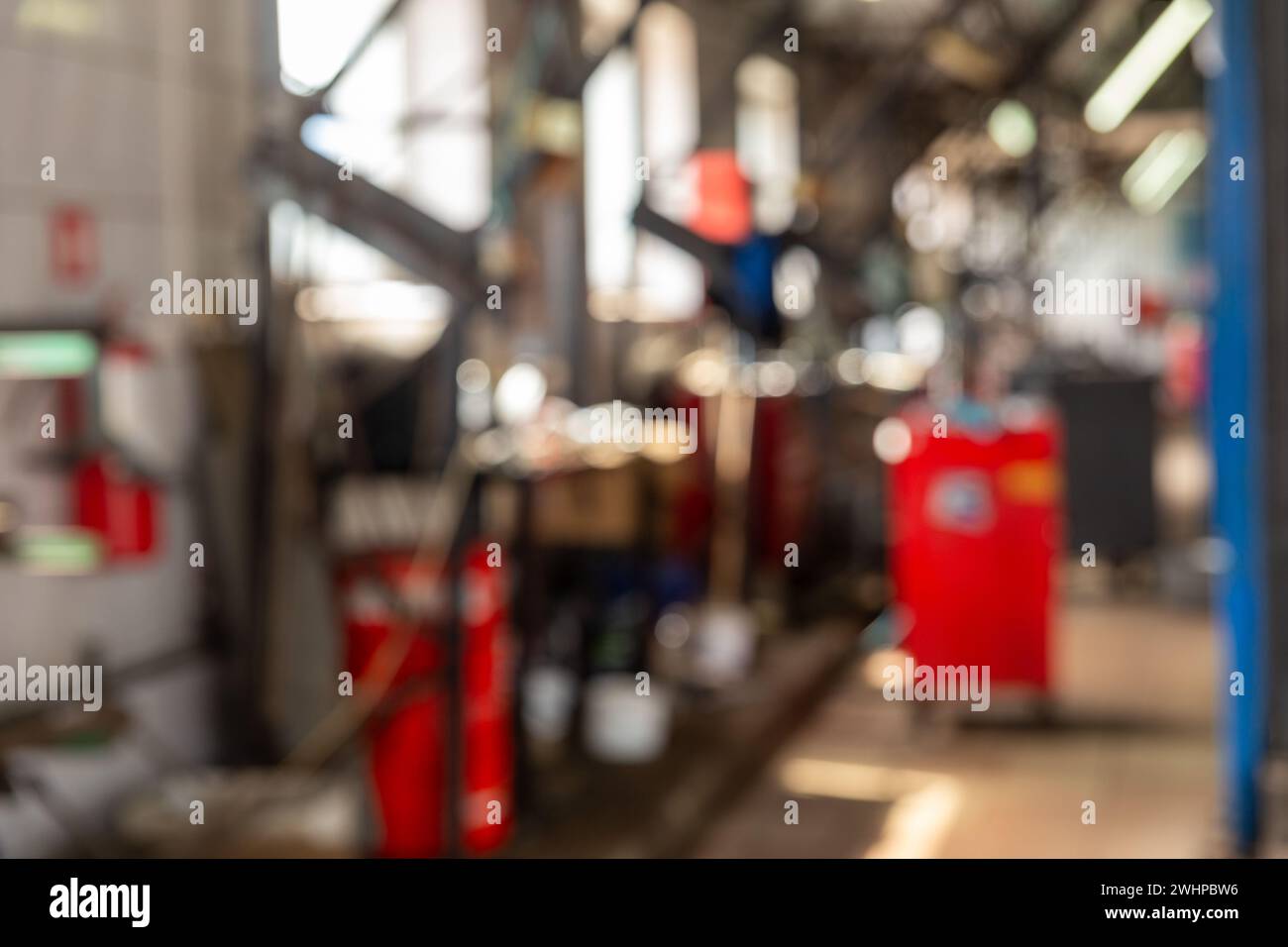 Blurred background image with cars in automobile repair service center ...