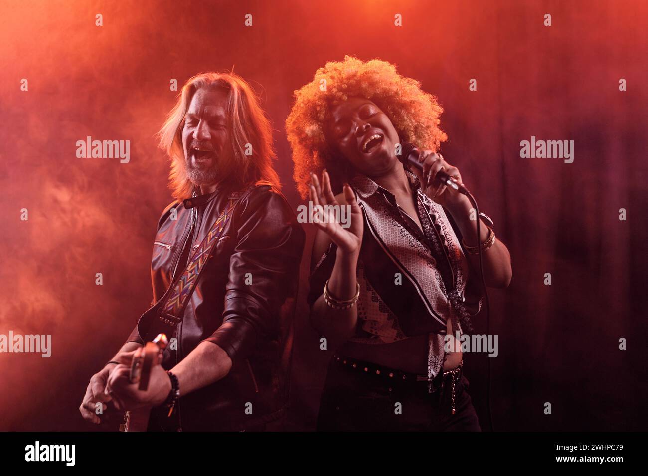 Waist up portrait of soul band performing on stage in nightclub African ...