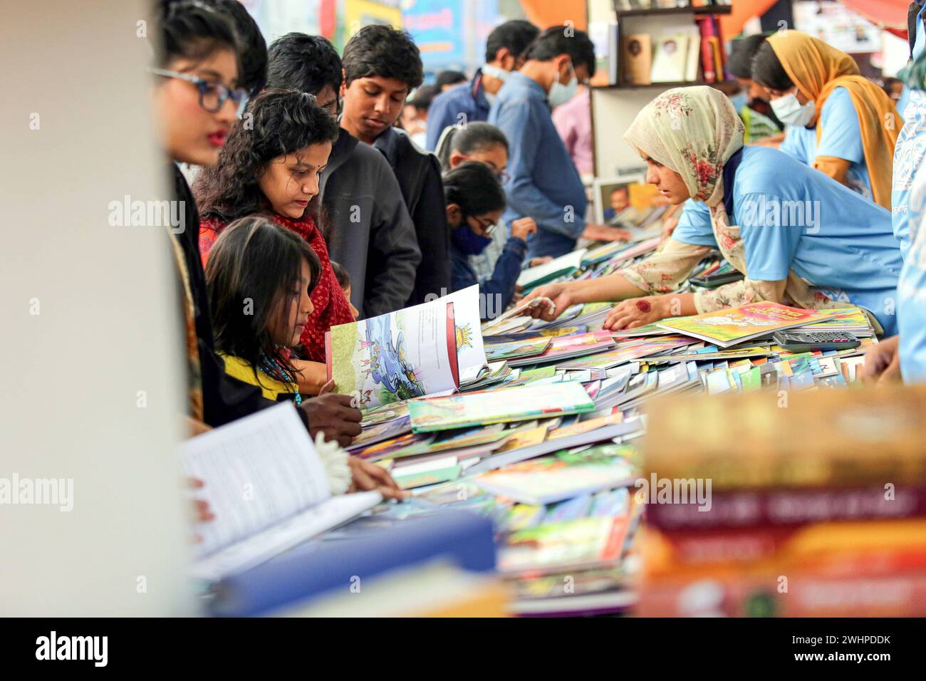 Buchmesse in Dhaka Visitors read books at the national book fair named Ekushey Boi Mela in Dhaka ...