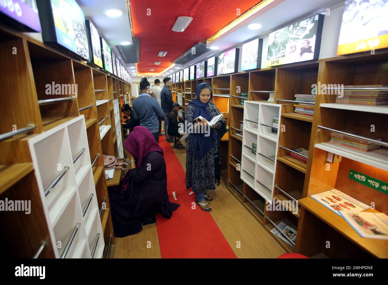 Dhaka, Bangladesh. 11th Feb, 2024. Visitors read books at the national book fair named Ekushey ...